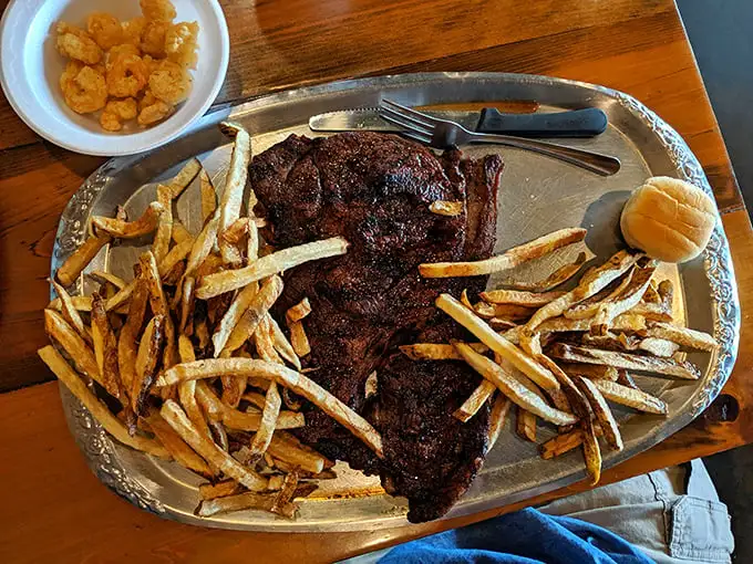 Porterhouse steak: Meat paradise found! This porterhouse doesn't need fancy garnishes—it's the superstar performer that draws crowds from counties away.