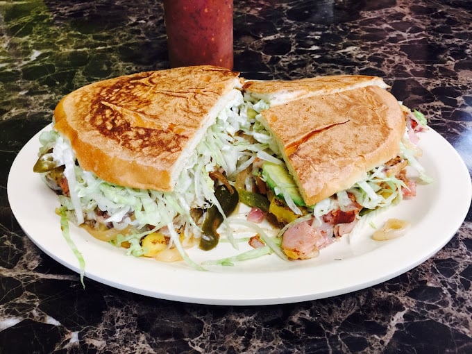 The torta – where sandwich architecture meets artistic vision. That cabbage mountain isn't just garnish; it's structural reinforcement for flavor skyscrapers.