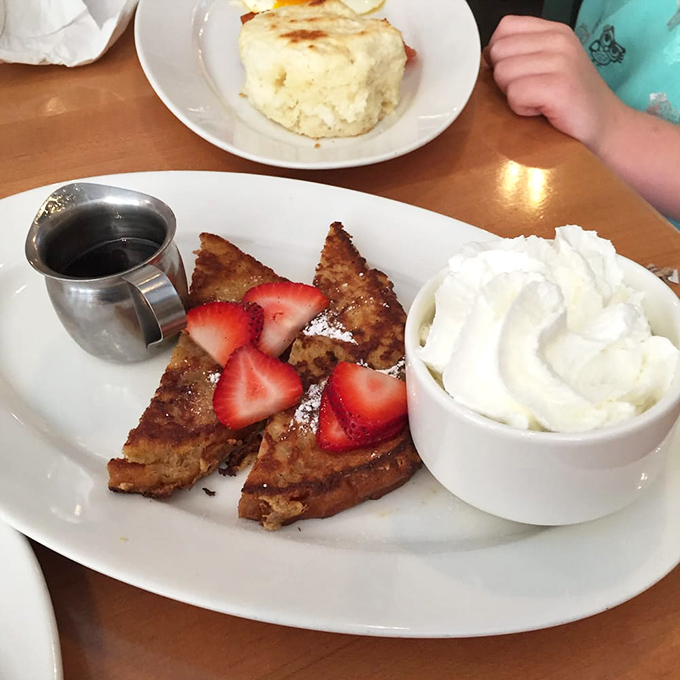 French toast that makes you forget all other breakfast foods exist. Those strawberries aren't garnish—they're supporting actors in a delicious drama.