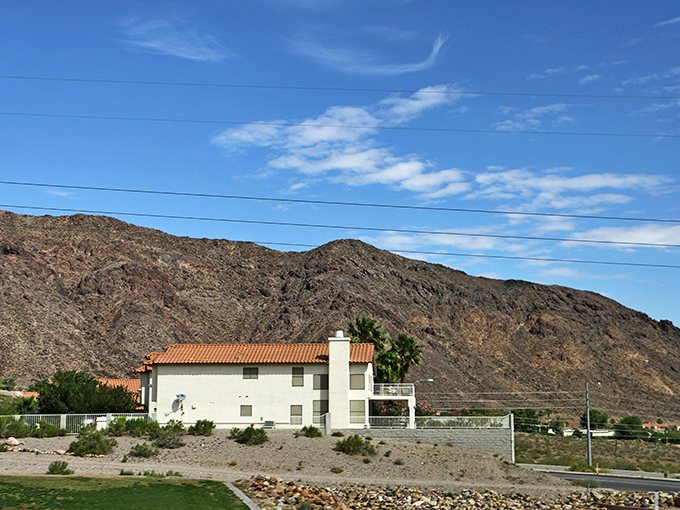 Boulder City: "Boulder City's homes nestle against rugged desert mountains, the contrast between domestic comfort and wild terrain capturing Nevada's distinctive character."