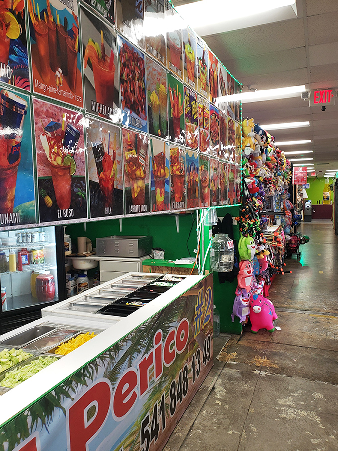 A rainbow explosion of fruit drinks lines the wall, making corporate smoothie chains look like they missed the memo on color theory.