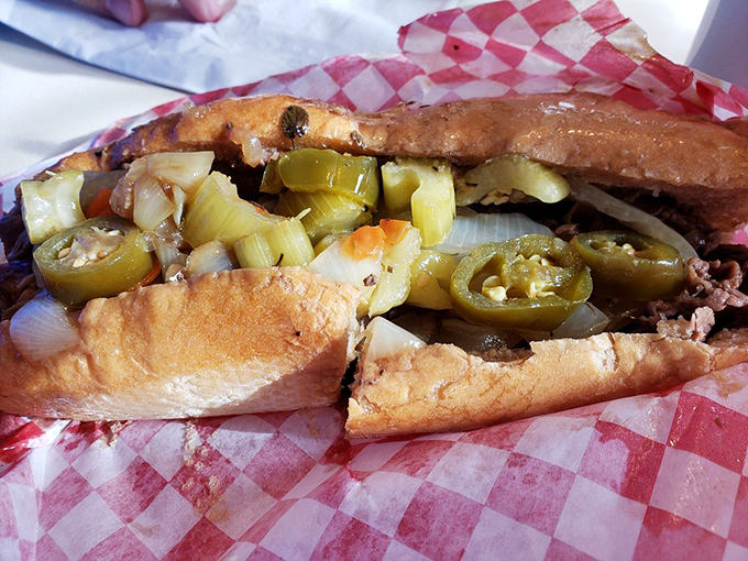 Green peppers peeking out like they know they've hit the jackpot—nestled between bread and beef in this Italian-American masterpiece.