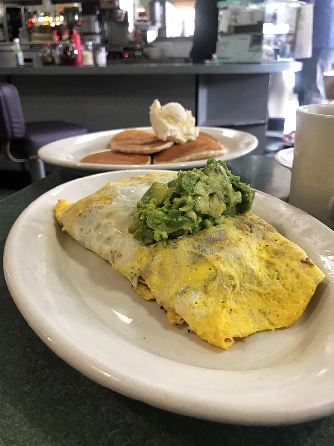 Not just an omelet—it's breakfast wearing a sombrero. That melted cheese pulls like the final scene in a food commercial.