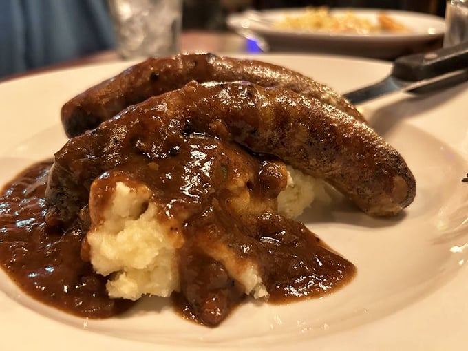 Bangers and mash with gravy so rich it could buy a small island—comfort food that hugs you from the inside out.