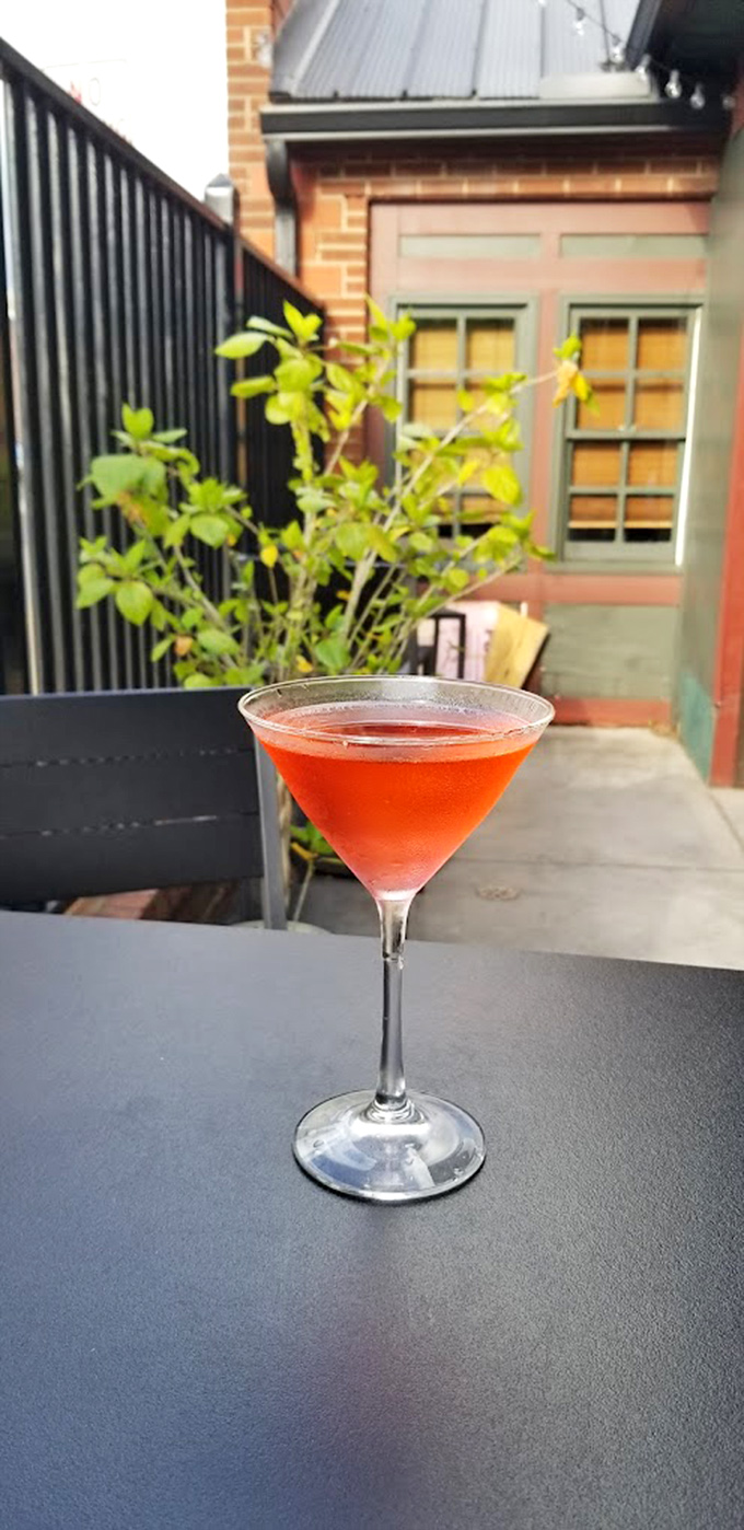 A ruby-red cocktail catching the afternoon light – liquid proof that happy hour at Olde Jaol is taken as seriously as dinner.