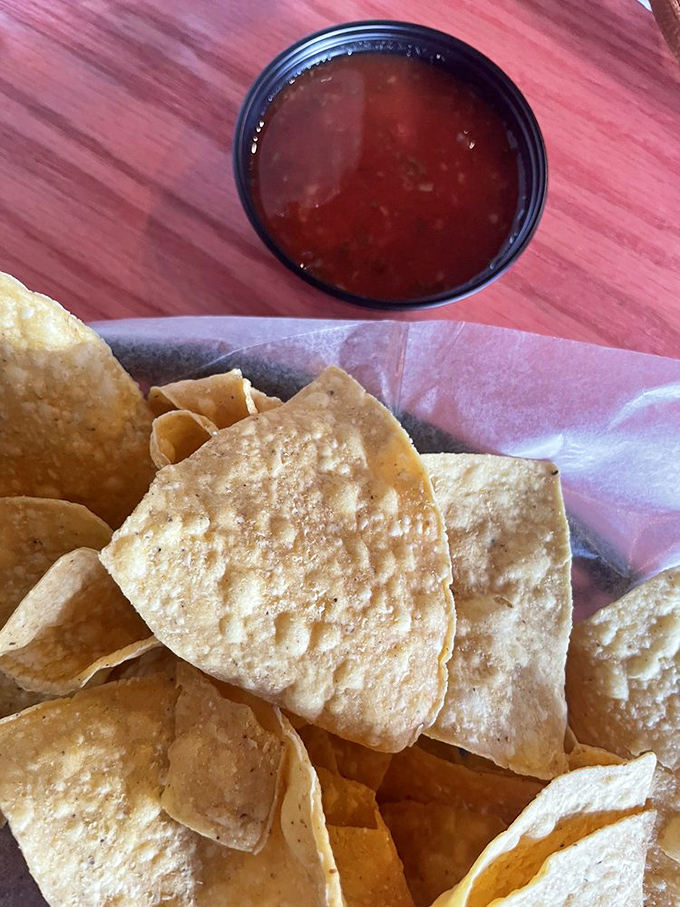 These aren't your sad, stale bar chips—these are proper, freshly-fried tortilla triangles that crackle with each bite, paired with salsa that means business.