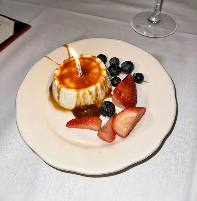A sweet finale worth saving room for – caramel-drizzled flan with fresh berries that makes you question your lifelong allegiance to chocolate.