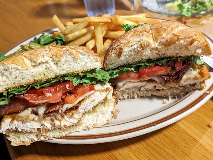 This sandwich isn't just lunch—it's architecture. Layers of goodness stacked between fresh bread with fries standing guard. No skimpy portions here!