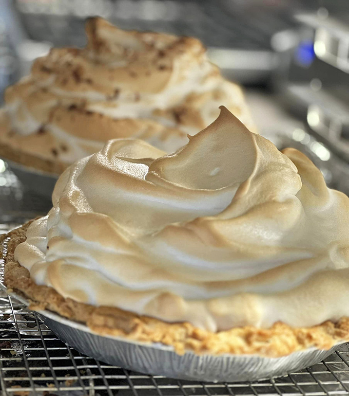 Lemon meringue pie wearing a cloud-like hat of perfectly toasted meringue—sunshine and comfort served on a plate.