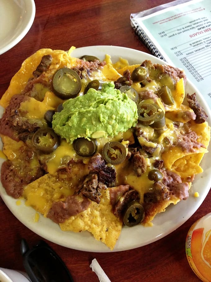 Nachos that laugh in the face of minimalism. Every chip supports a skyscraper of beans, cheese, jalapeños, and guacamole—architecture you can eat.