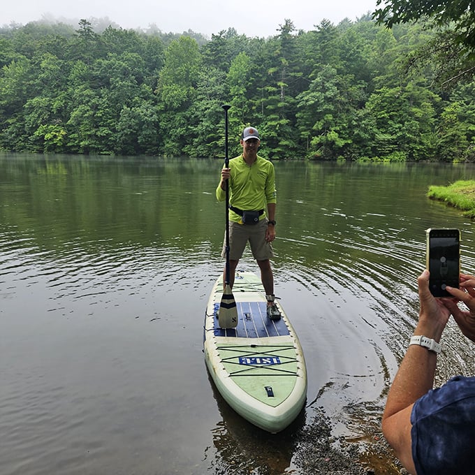 Paddle boarding: where the tranquility of nature meets your desperate attempt to maintain balance and dignity. This calm mountain lake forgives all first-timer wobbles.