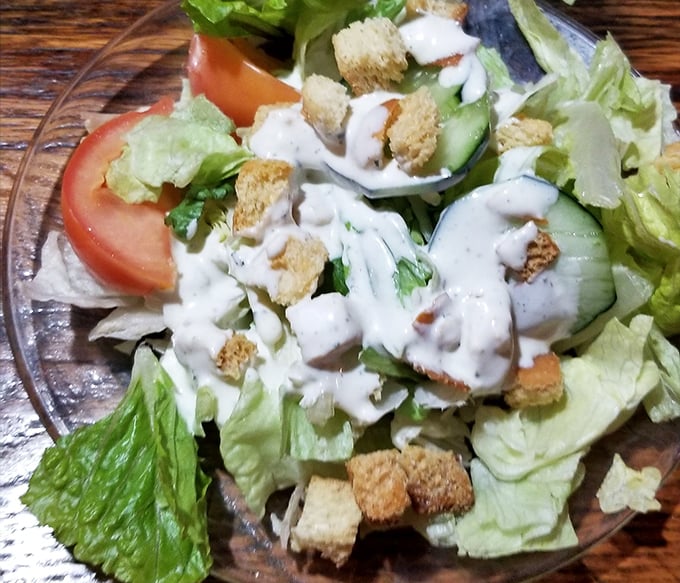 Even the salad looks like it's having a good time, dressed up in ranch and croutons like it's heading to the veggie prom.