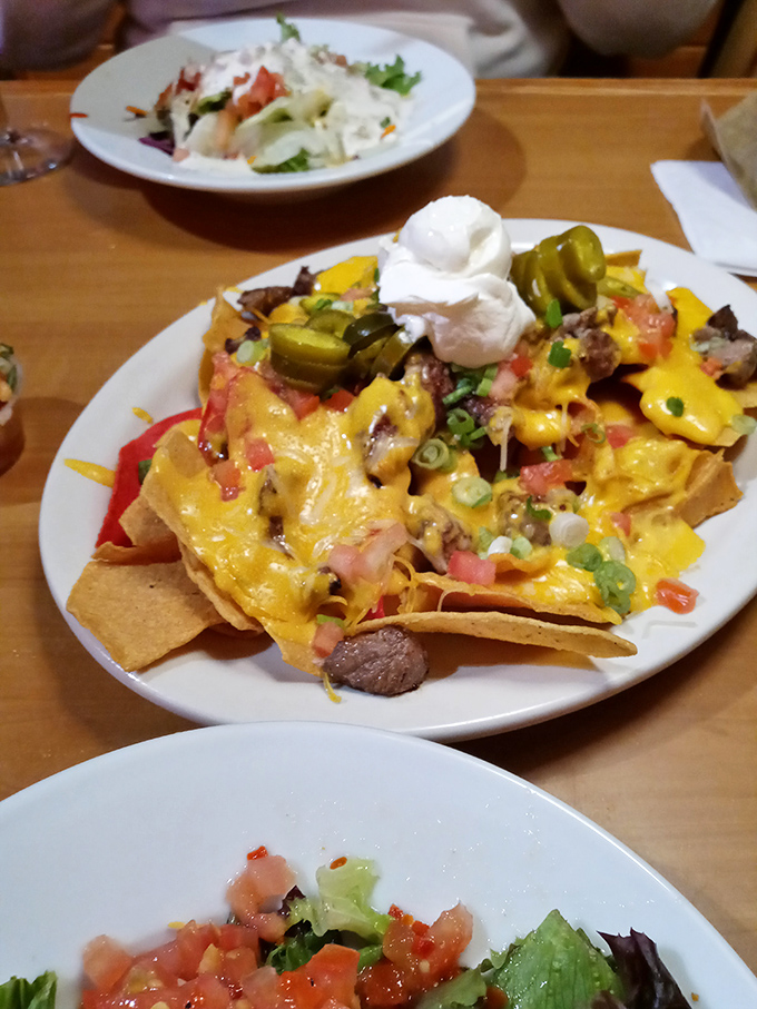 These nachos aren't just topped—they're architecturally engineered to ensure every chip experiences maximum flavor coverage.