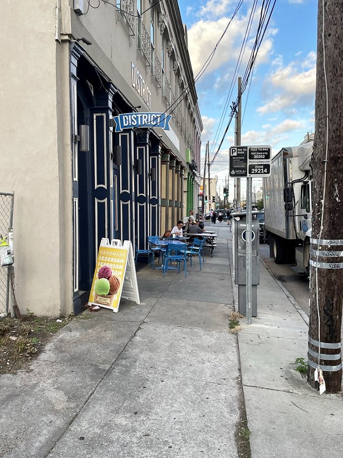 The Lower Garden District sidewalk view—where New Orleans architecture meets deli culture in a beautiful collision of worlds worth exploring.