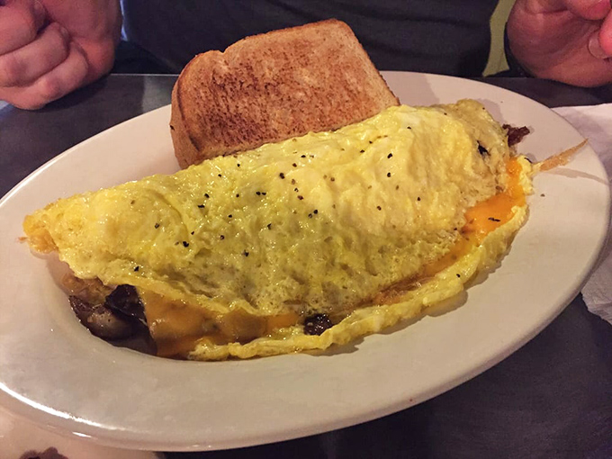 The veggie omelet that makes eating your vegetables feel like cheating at adulthood—fluffy eggs cradling a garden's worth of colorful produce.