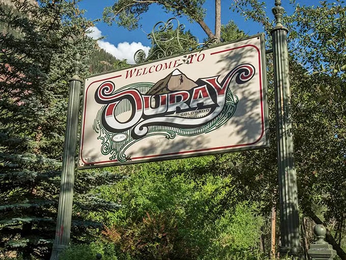 The welcome sign promises exactly what Ouray delivers – a town with equal parts Victorian charm and rugged mountain character.
