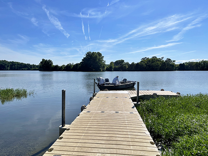 A wooden dock stretching into calm waters—nature's invitation to slow down. In our hyperconnected world, this simple fishing spot is the ultimate luxury.