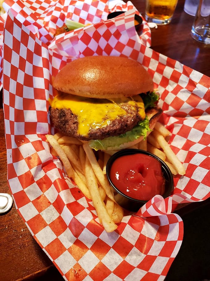 The classic American cheeseburger, perfected. That melty yellow cheese and red-checkered paper say "happiness" in any language.