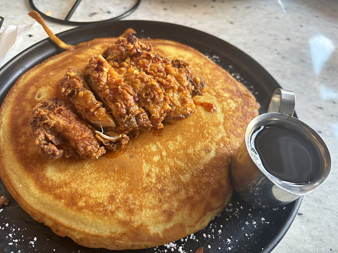 This chicken-topped pancake isn't just breakfast—it's breakfast that's living its best life, with maple syrup standing by for the perfect sweet-savory marriage.