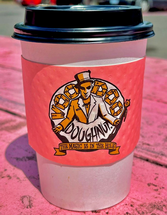 Coffee served with a side of personality. Their signature pink cups proclaim "The magic is in the hole" – the perfect companion for your sugar adventure.
