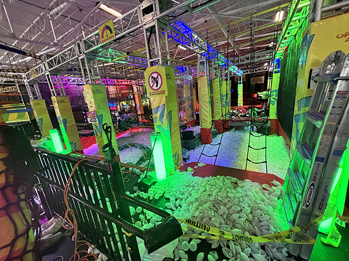The foam pit obstacle course glows with neon promise—a soft landing for hard-charging warriors of all ages.
