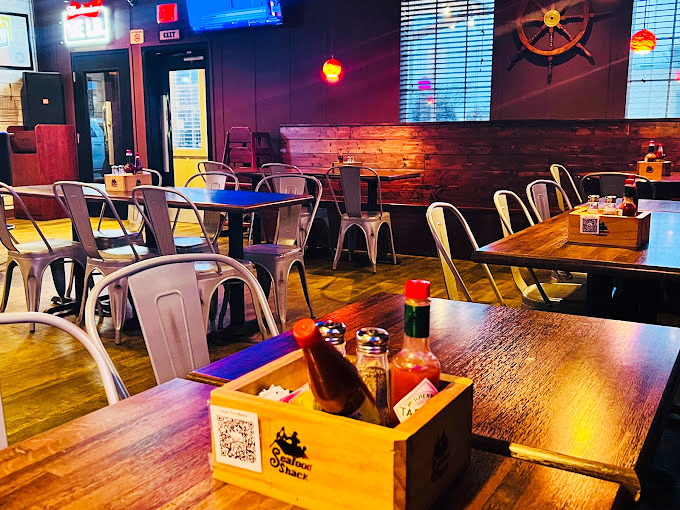 Modern meets maritime in this thoughtfully designed dining space. Those wooden tables have probably witnessed countless "Oh my goodness, you have to try this" moments.