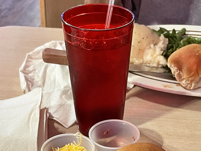 That crimson drink isn't just refreshing – it's practically the unofficial state beverage of every serious steakhouse worth its salt.
