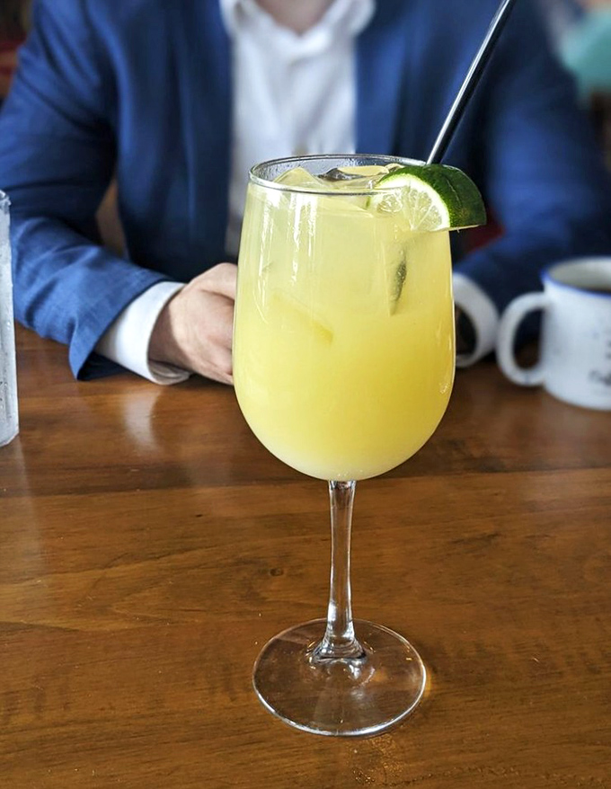 This sunshine-yellow cocktail doesn't just quench thirst—it announces that vacation mode has officially begun, lime garnish standing by for duty.