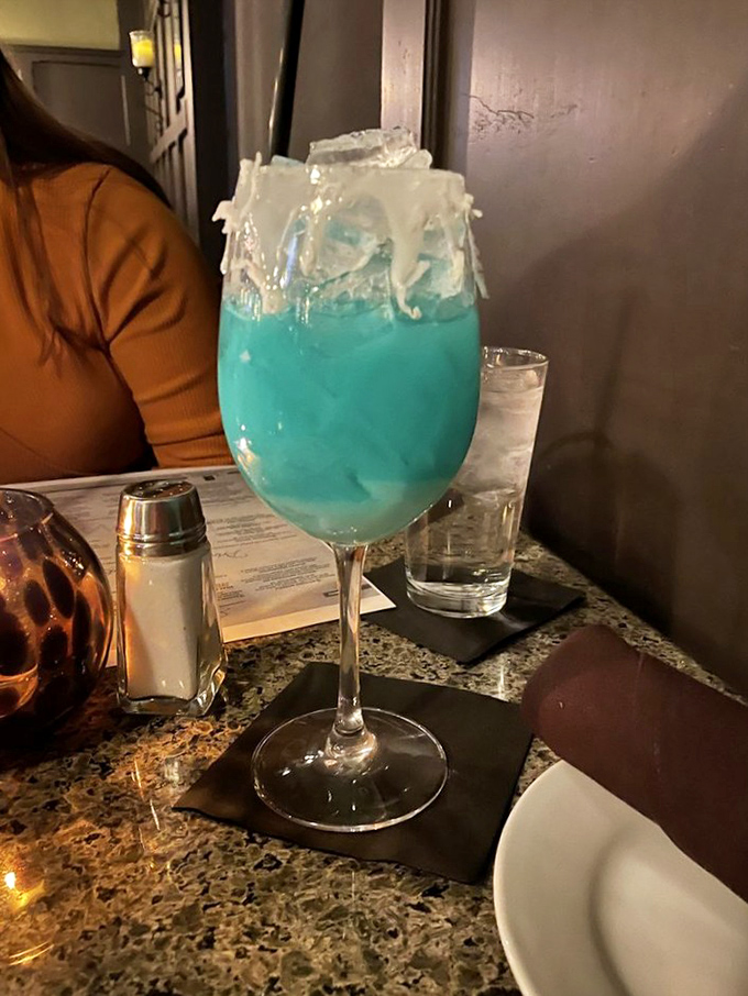 This electric blue cocktail isn't just a drink—it's vacation in a glass, with a side of "I'll worry about adulting tomorrow."