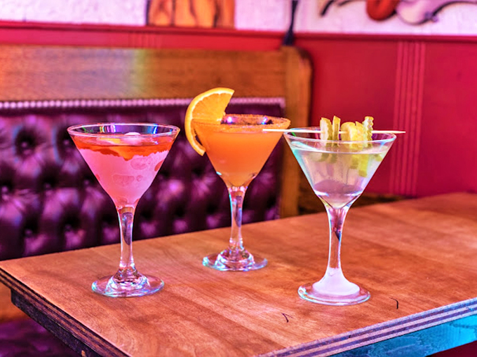 Cocktails that glow like the signs above them. In a place this colorful, even the drinks dress for the occasion.