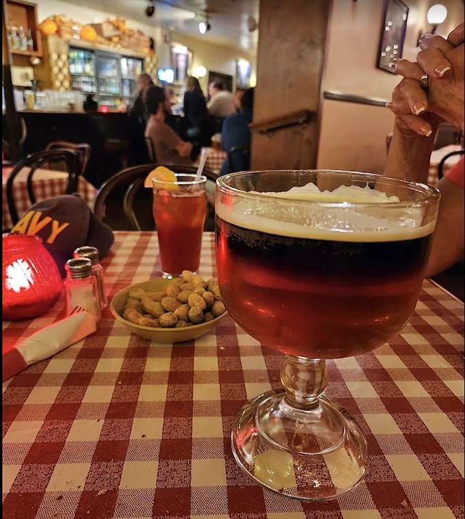 A proper goblet of beer alongside peanuts—the perfect pairing since... well, forever. Some traditions exist because they're simply right.