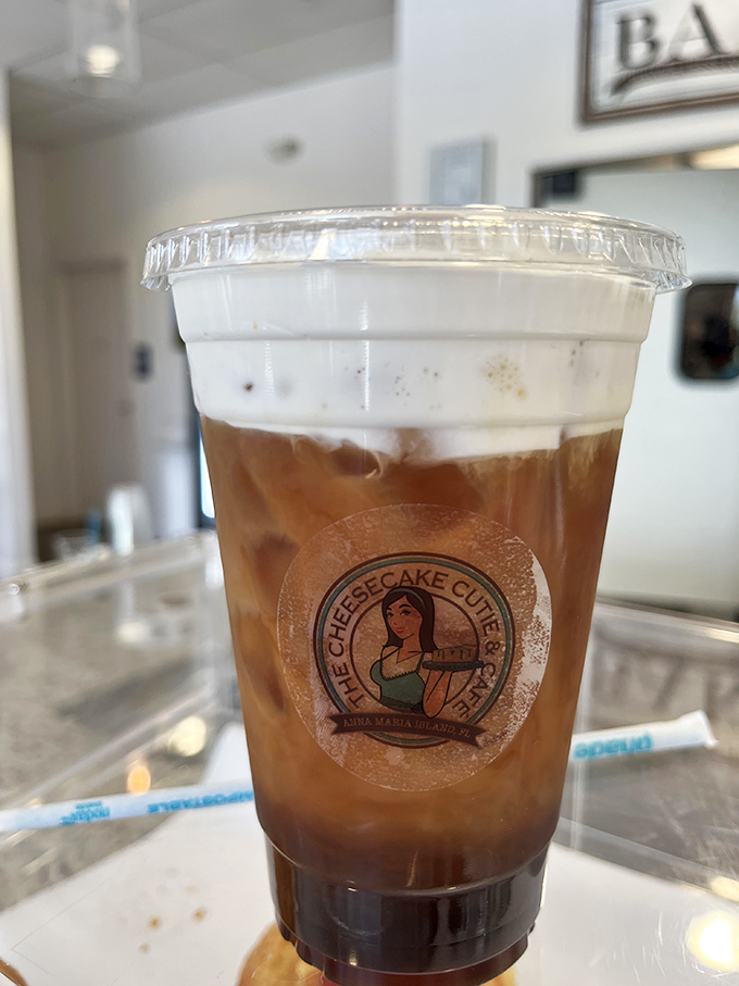 This isn't just iced coffee; it's summer in a cup, wearing the café's logo like a badge of honor for serious refreshment seekers.