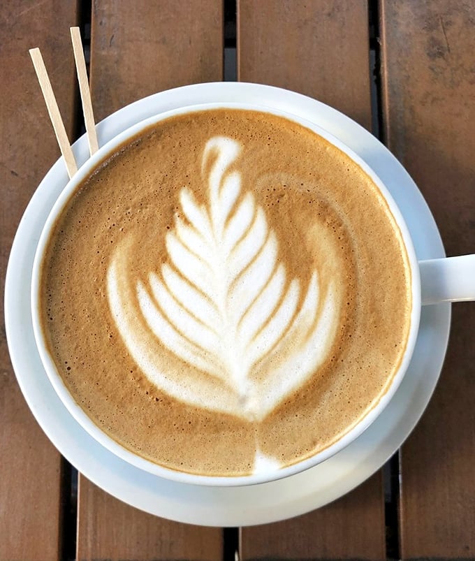 Latte art so pretty you almost don't want to drink it. Almost. Coffee this good won't stay photogenic for long.