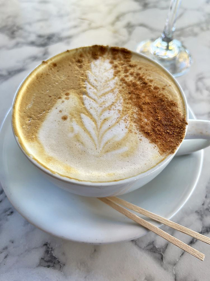 This latte isn't just coffee—it's liquid art with a leaf pattern so perfect you almost feel guilty disrupting it with your first sip. Almost.