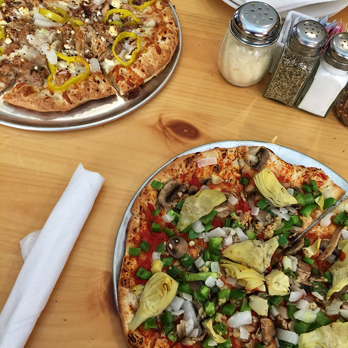 Pizza perfection isn't just about the crust – though that char is textbook beautiful. It's the artful arrangement of toppings that turns eating into an event.