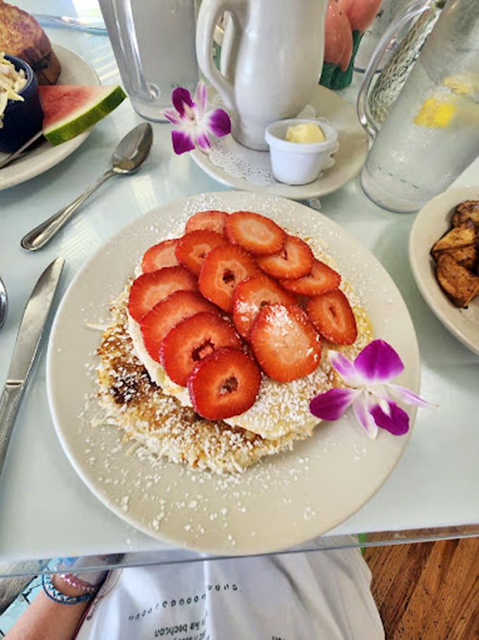 Strawberry pancakes that make you wonder if Florida's fruit fields sent over their A-team, complete with a dusting of powdered sugar and that signature orchid garnish.
