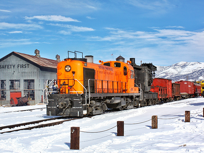 Ely: "The Nevada Northern Railway's vibrant orange locomotive cuts through winter's blanket, a moving museum that doesn't just display history—it powers through it."