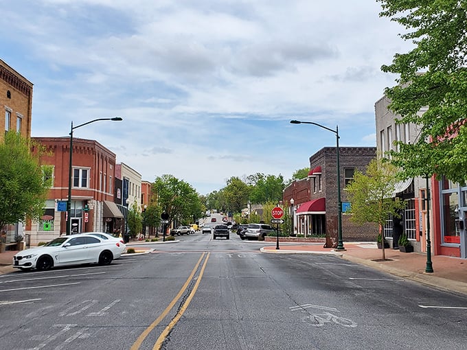 Siloam Springs' downtown curves gracefully along Sager Creek – a storybook setting where modern college life meets historic charm.