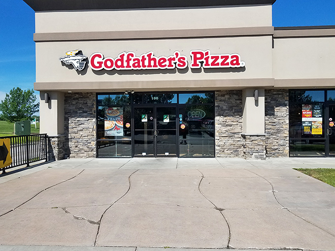 Godfather's Pizza (storefront): "Where other pizzas go to learn the meaning of 'substantial.' The heavyweight champion of heartland pies."