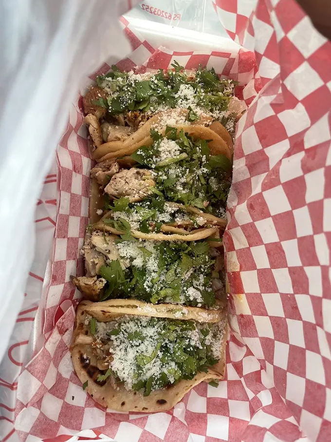 Four tacos lined up like soldiers ready for battle—the only casualties will be your hunger and your diet plans.