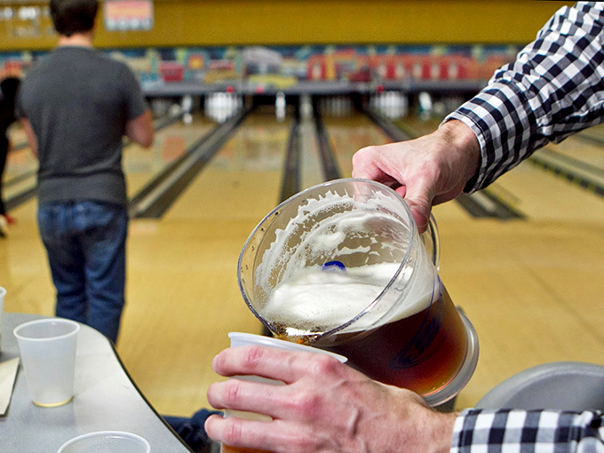 A perfectly poured beer in one hand, bowling ball in the other - life's delicate balancing act in athletic form.