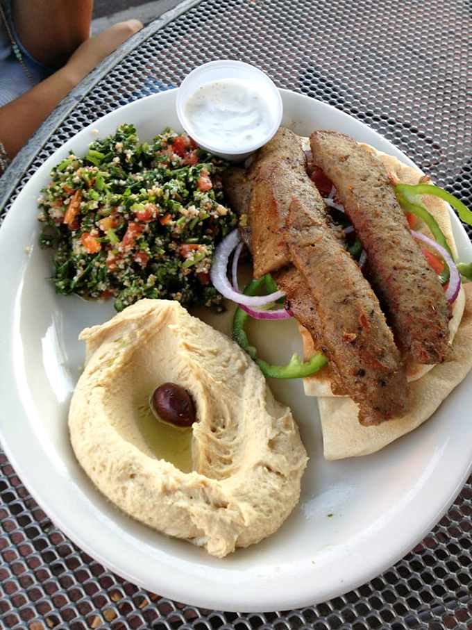 A perfect marriage of flavors—kebabs with tabbouleh and hummus. This plate doesn't need a dating app; it's already found its soulmates.