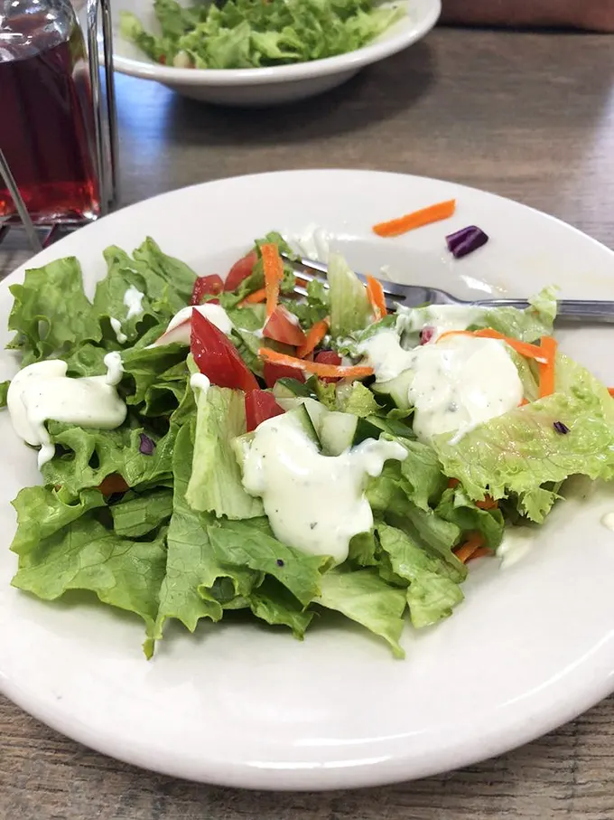 A house salad that proves vegetables can be more than an obligation—fresh, colorful, and dressed just right for those "maybe I should eat something green" moments.
