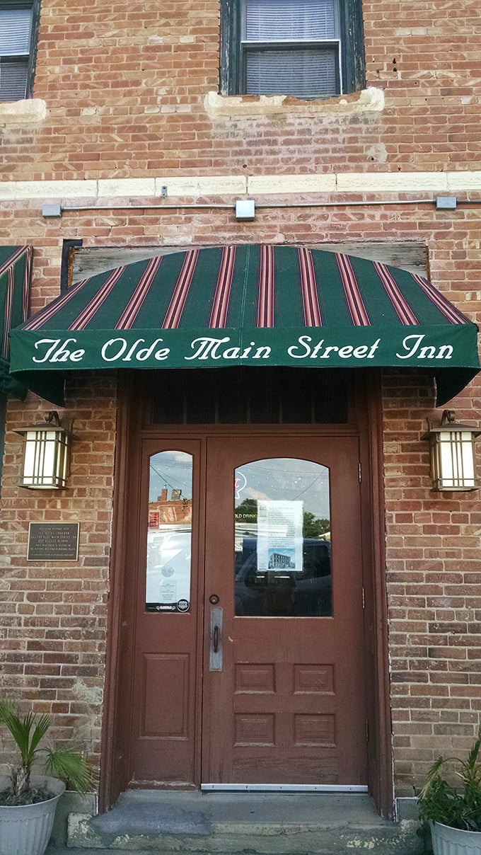 The Olde Main Street Inn's striped awning promises the kind of small-town hospitality that big cities try (and fail) to replicate.