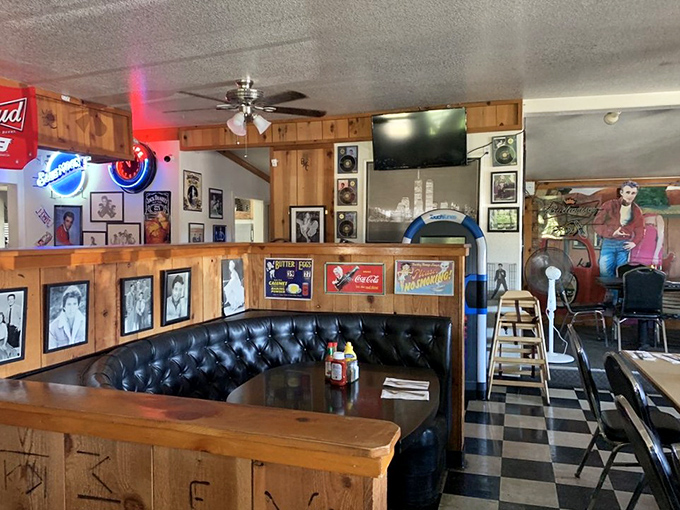 The black leather booth practically whispers "sit a while" as vintage memorabilia creates the perfect backdrop for both conversation and contemplation.