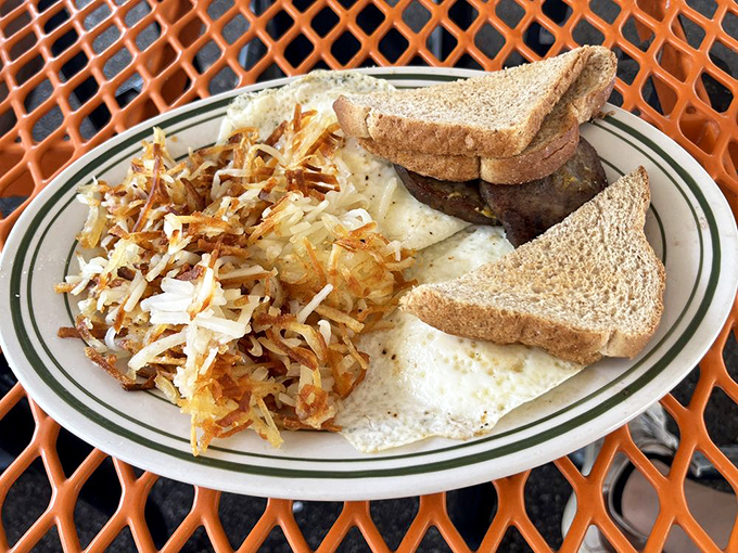 Breakfast served with geometric precision—crispy hash browns, perfectly folded eggs, and toast standing by for yolk management duties.