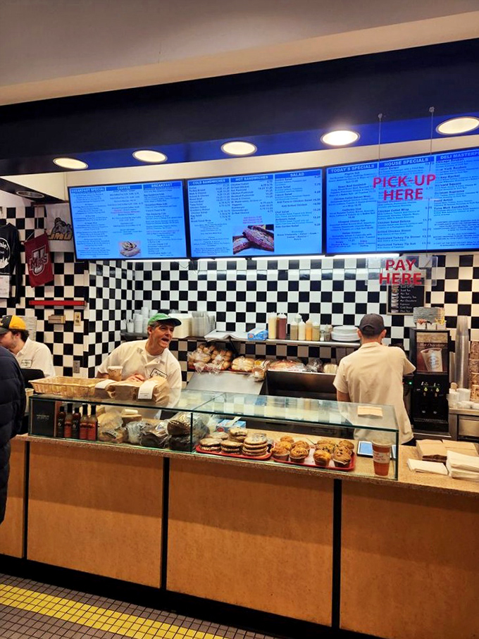 The classic black and white checkerboard floor isn't just decoration—it's a promise that this place takes its deli credentials seriously.