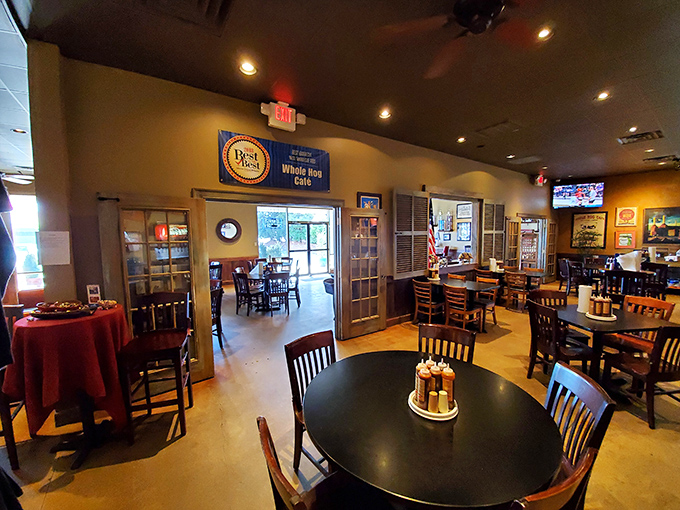 The dining room balances casual comfort with barbecue seriousness—note the "Best of" banner proudly displayed above the doorway.