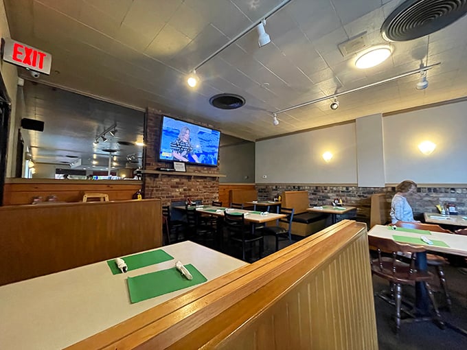 The dining area balances privacy with community—where solo newspaper readers and family gatherings coexist in breakfast harmony.