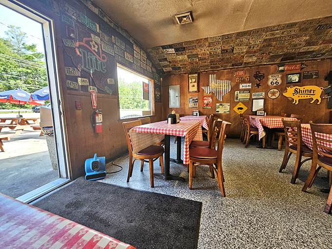 Checkered tablecloths, wooden chairs, and walls plastered with memorabilia—this isn't décor by design, it's atmosphere through authentic accumulation.